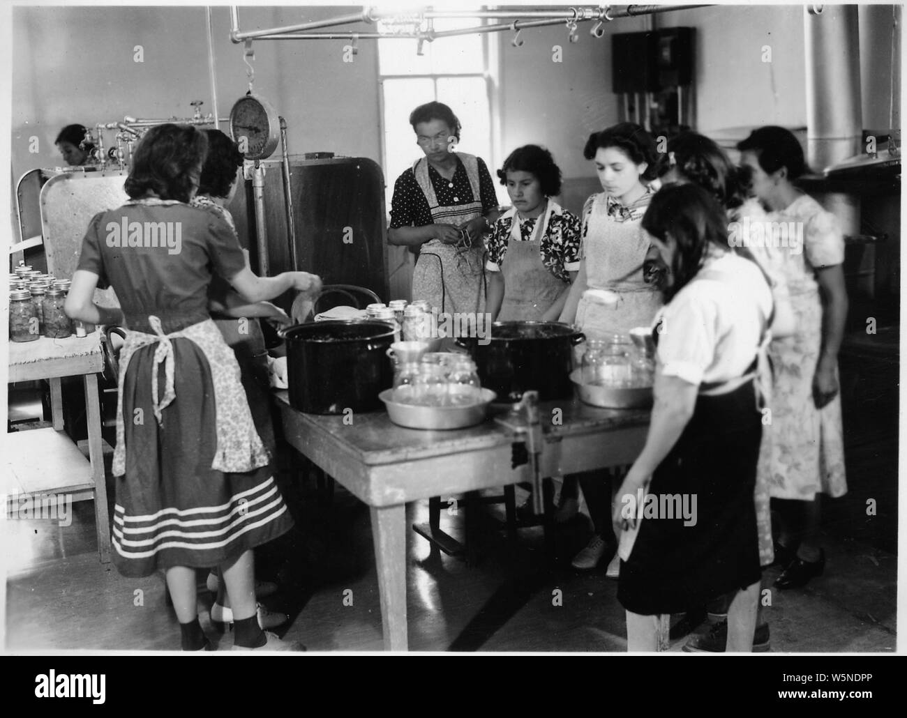 Group of women at a food canning class Stock Photo - Alamy