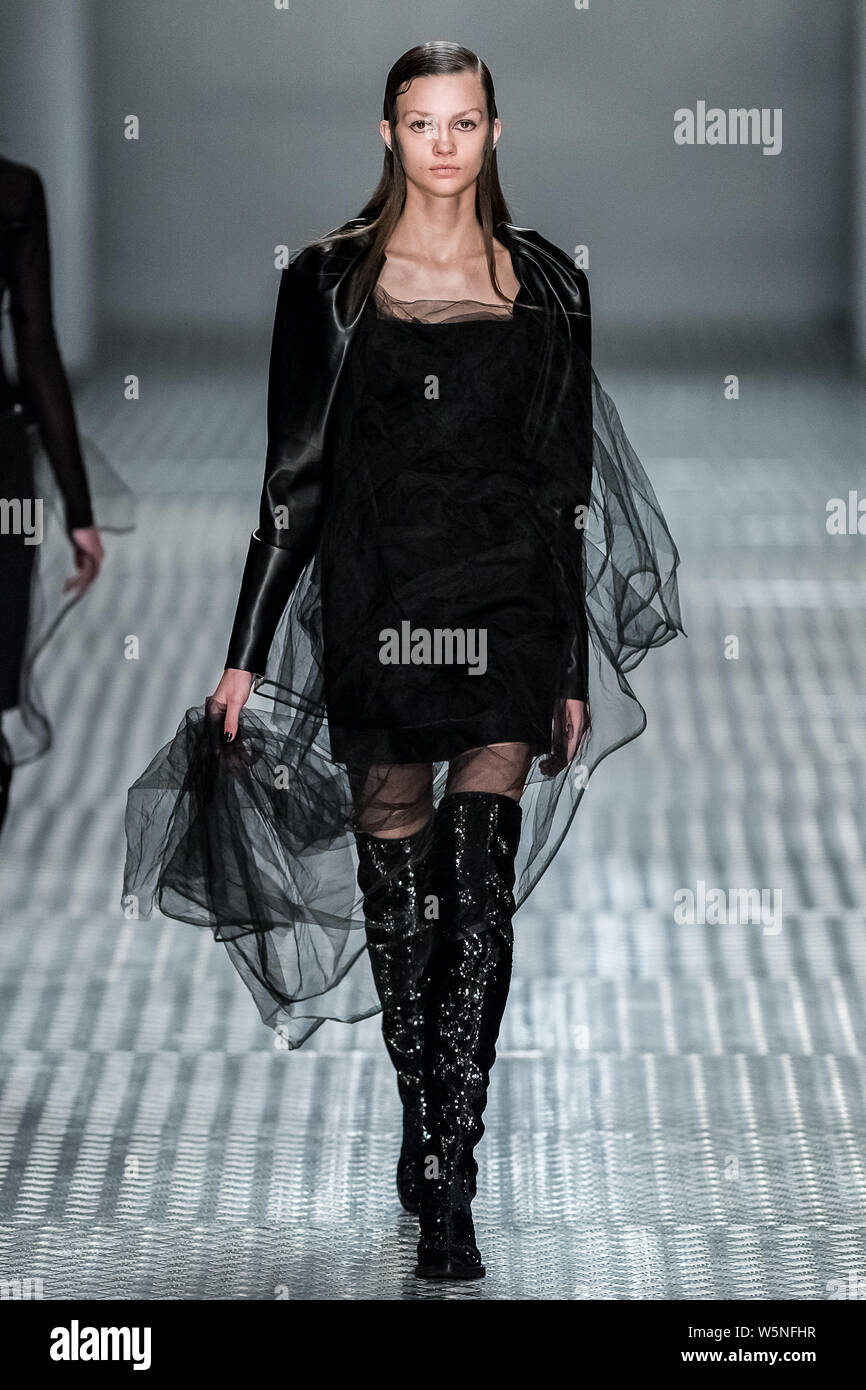 A model displays a new creation at the YOEYYOU show during the Shanghai ...