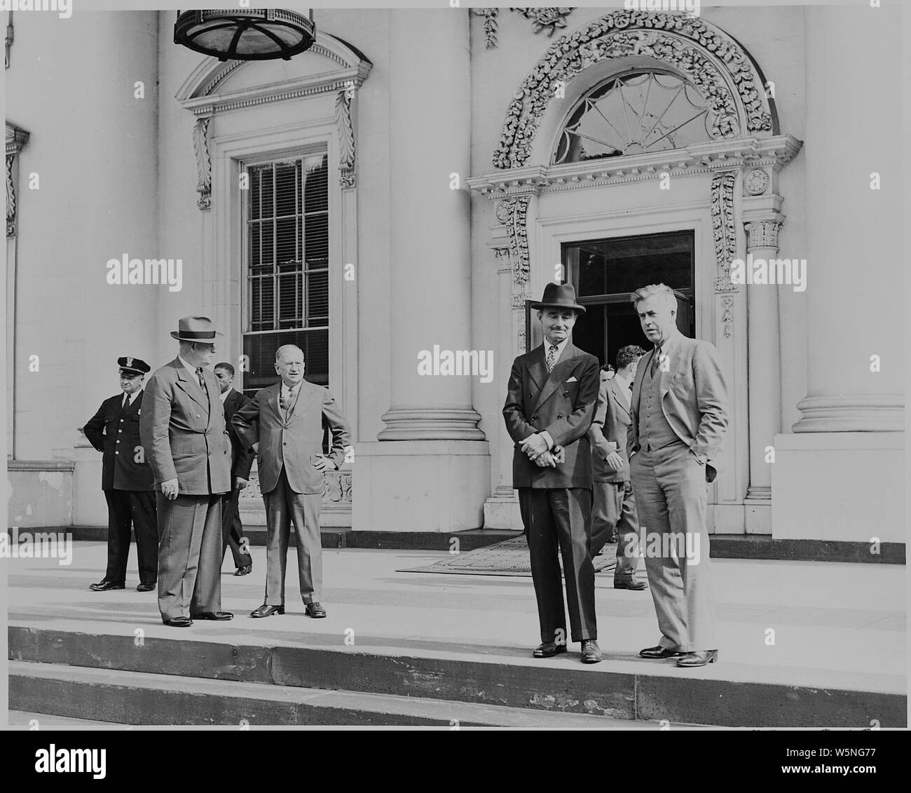 Harold Ickes, Henry A. Wallace, and other men standing in front of the ...