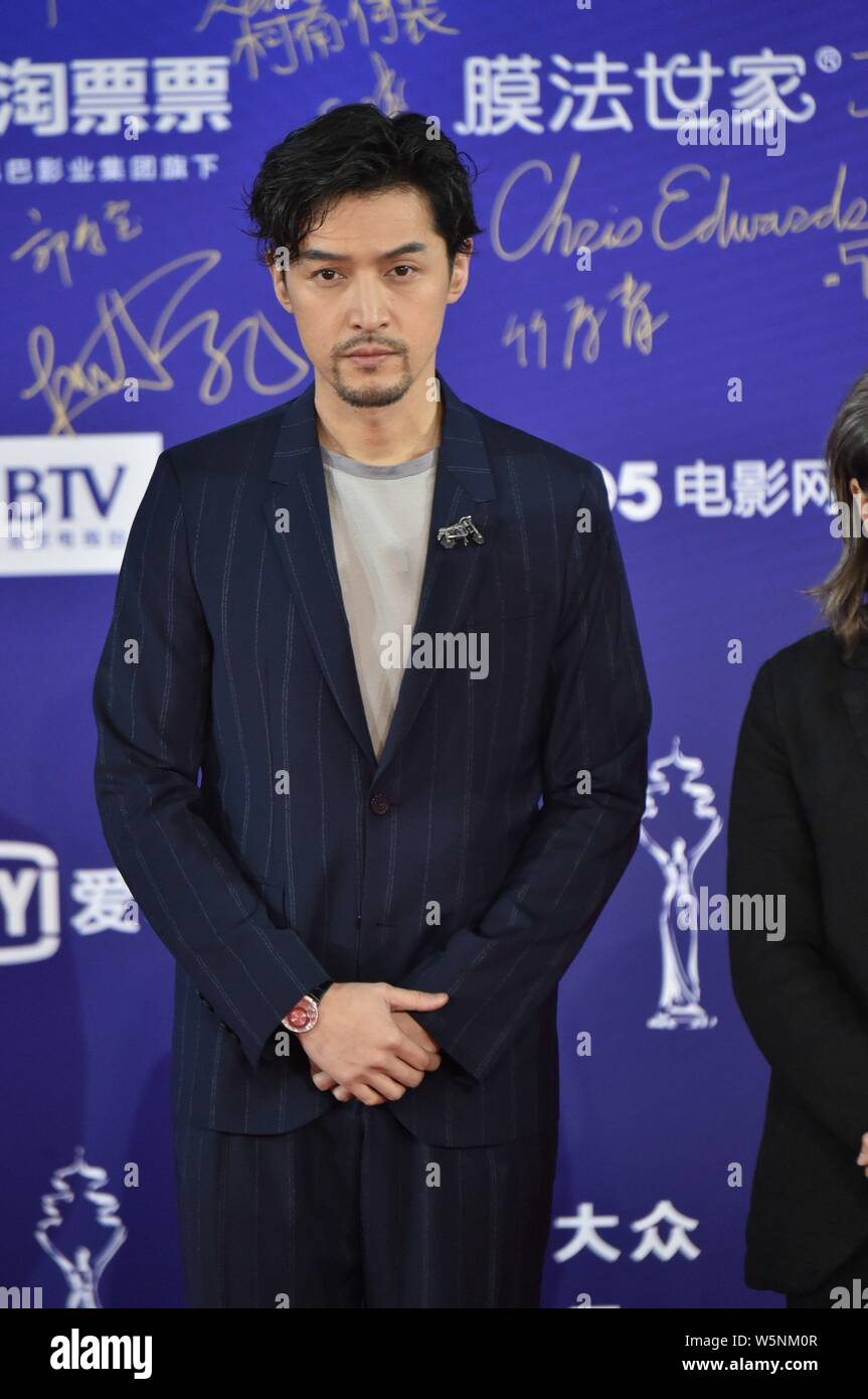 Chinese actor Hu Ge poses as he arrives on the red carpet for the ...