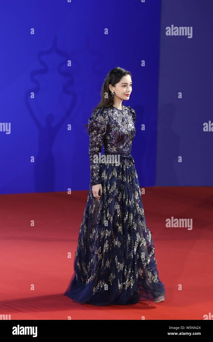 Hong Kong actress Angelababy poses as she arrives on the red carpet for the opening ceremony of ...