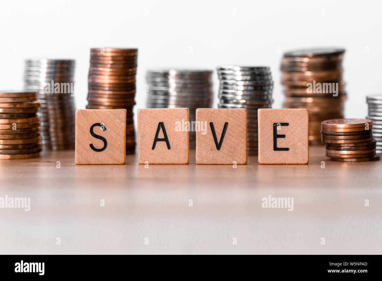 Save sign with coins in the background Stock Photo - Alamy
