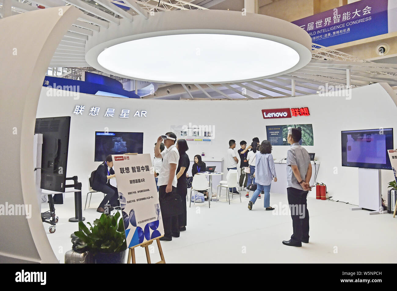 People visit the stand of Lenovo during the 3rd World Intelligence ...