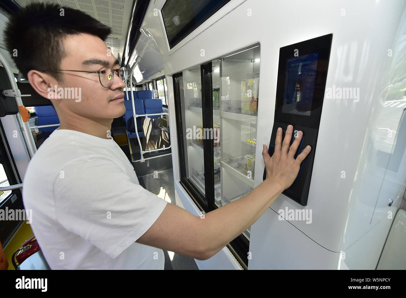 A passenger swipes his hand through a fingerprint recognition system to ...
