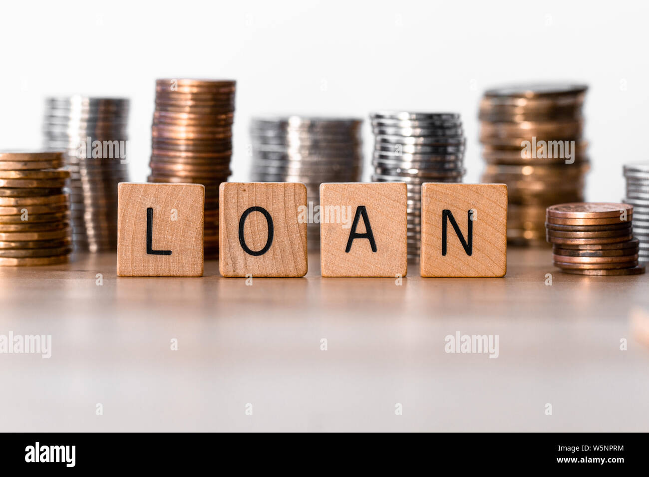 Loan sign with coins in the background Stock Photo - Alamy
