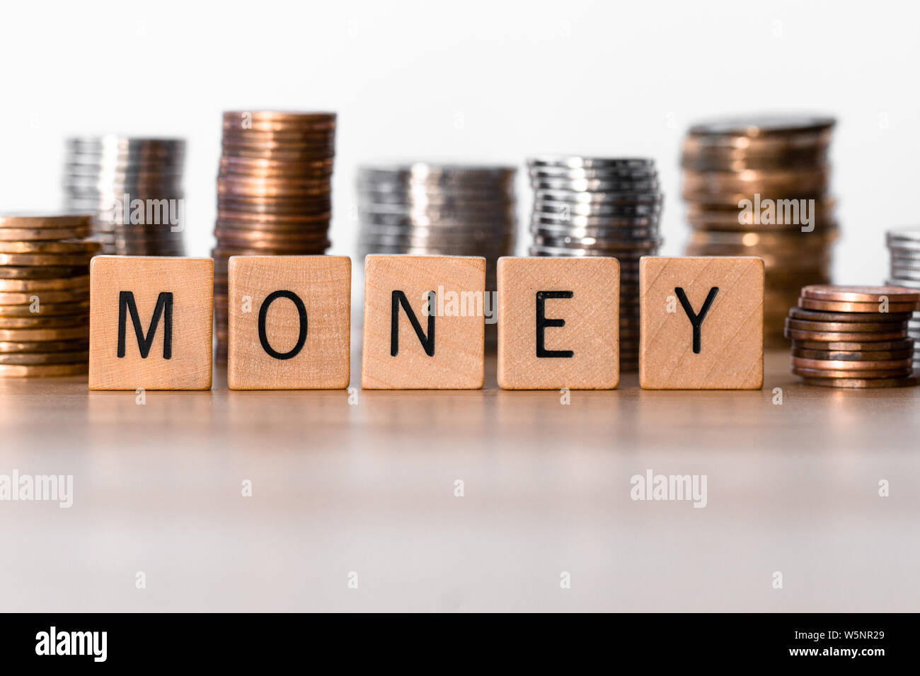 Money sign with coins in the background Stock Photo - Alamy