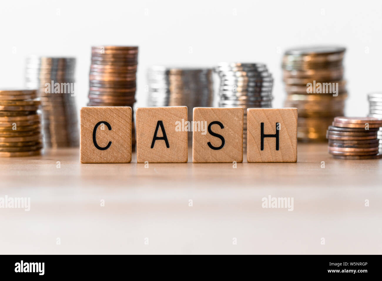 Cash sign with coins in the background Stock Photo - Alamy