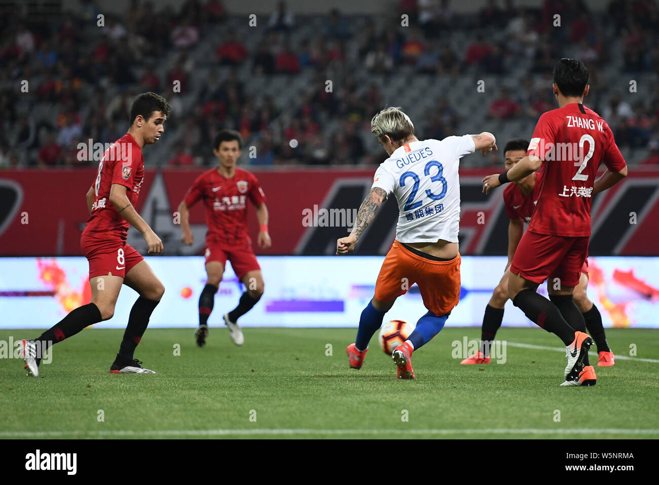 Brazilian football player Roger Krug Guedes, known as Roger Guedes, center, of Shandong Luneng ...