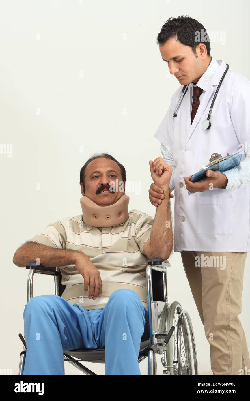 Male doctor taking pulse of patient Stock Photo - Alamy