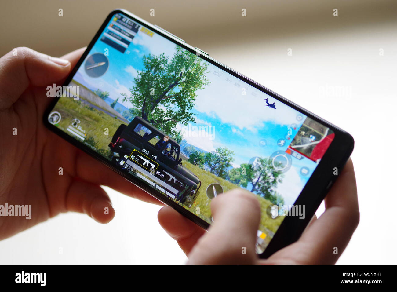 A Chinese mobile game player plays Tencent's anti-terrorist themed game ...