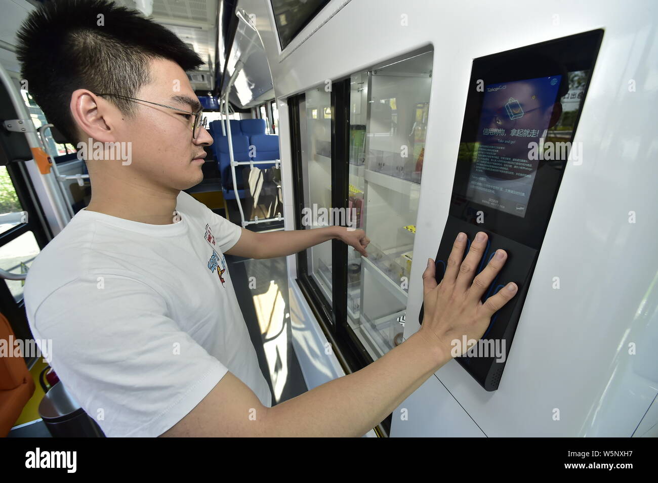 A passenger swipes his hand through a fingerprint recognition system to ...
