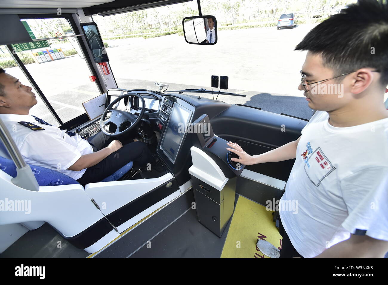 A passenger swipes his hand through a fingerprint recognition system to ...