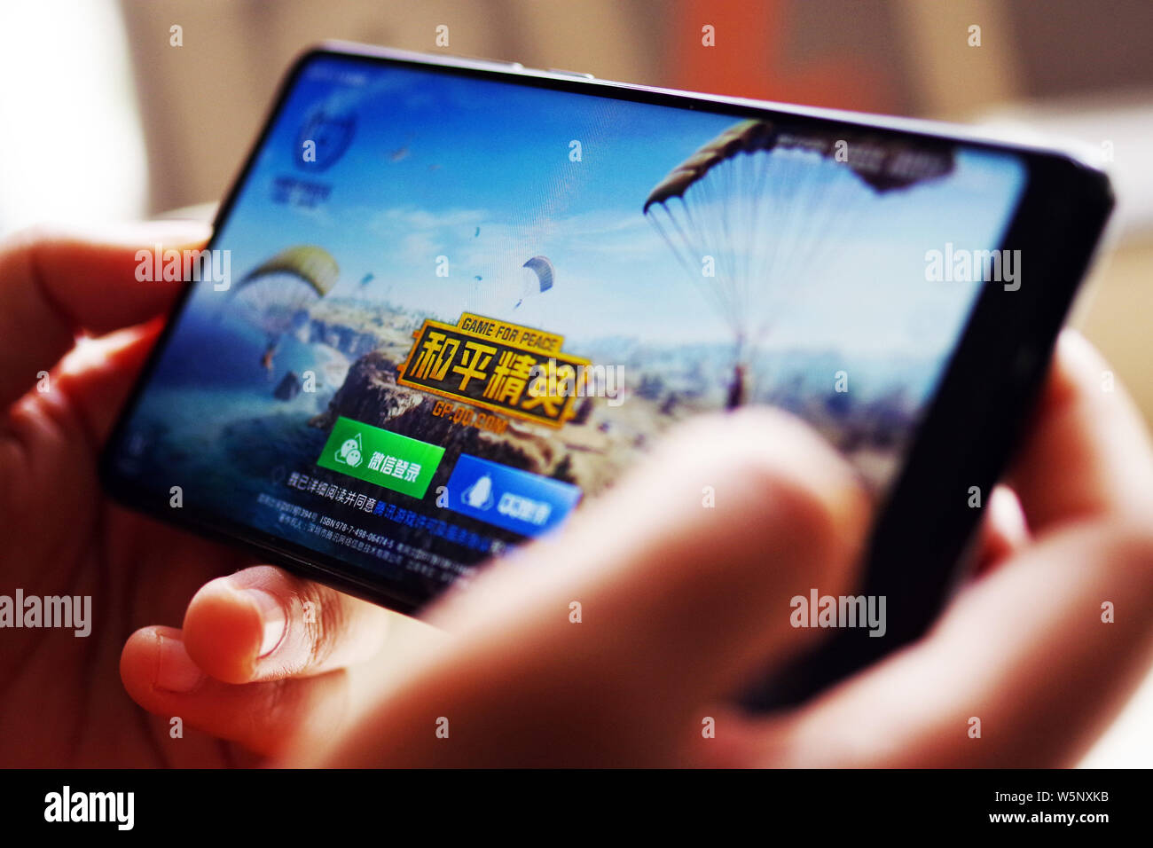 A Chinese mobile game player plays Tencent's anti-terrorist themed game ...