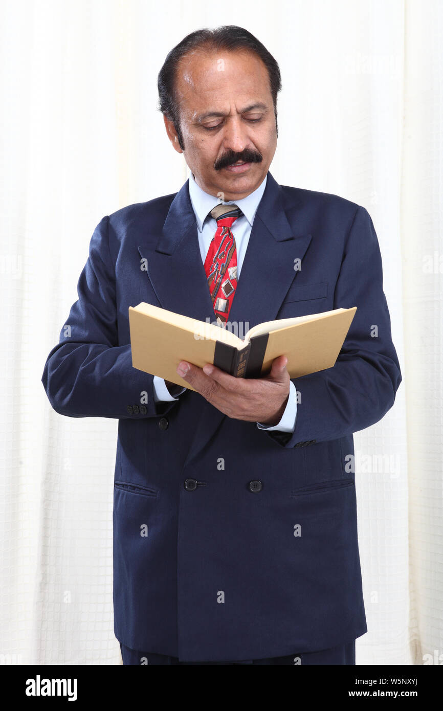 Businessman reading a book Stock Photo - Alamy