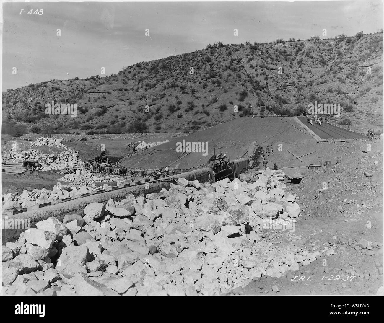 Intake diversion dam. View showing rock riprap and nearly completed ...