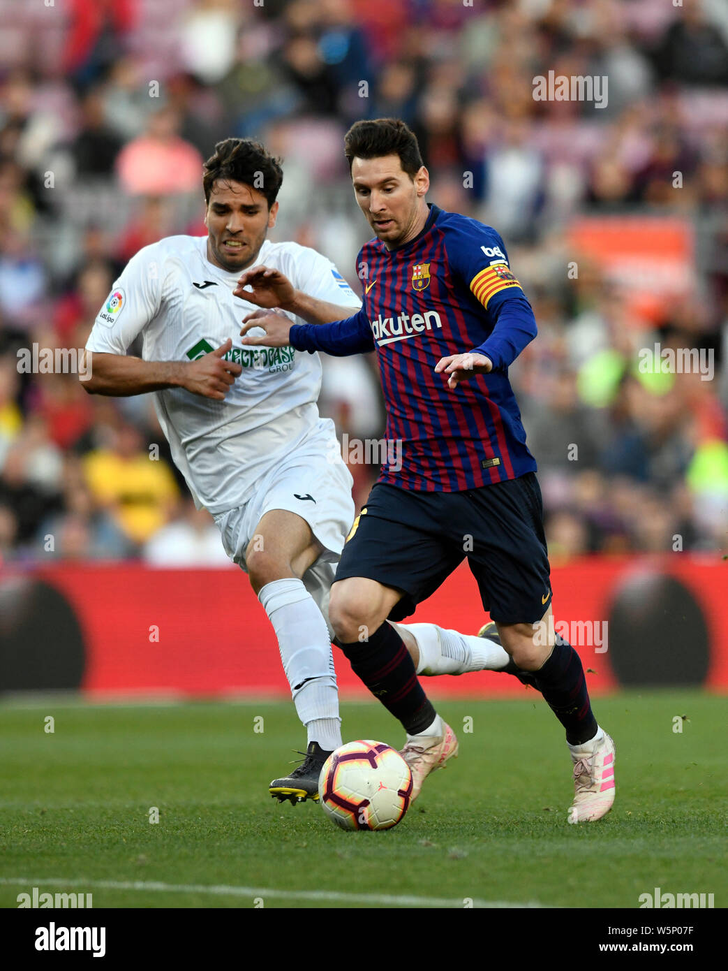 Lionel Messi, right, of FC Barcelona challenges Leandro Cabrera of ...