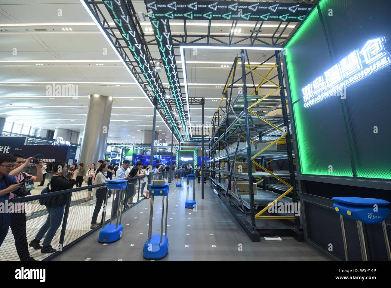 People visit the stand of Cainiao, the logistics arm of Alibaba, during ...