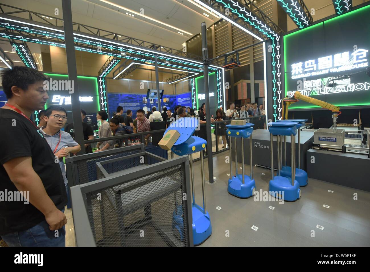 People visit the stand of Cainiao, the logistics arm of Alibaba, during ...
