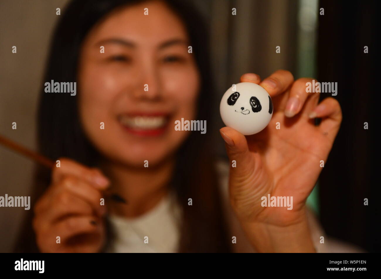 A visitor shows a dessert featuring shape of giant panda during the ...