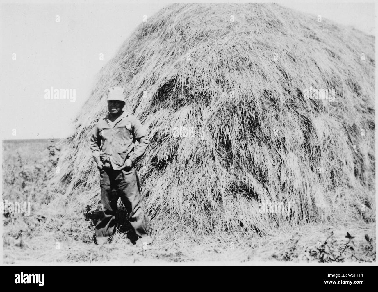 Isaac Afraid of Bear in front of his hay stack Stock Photo - Alamy