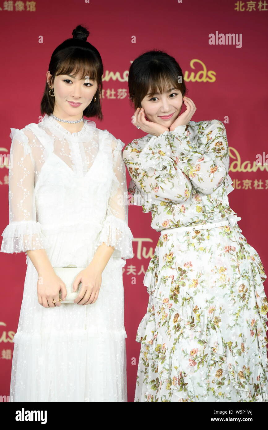 Chinese actress Andy Yang or Yang Zi poses with the wax figure of her ...