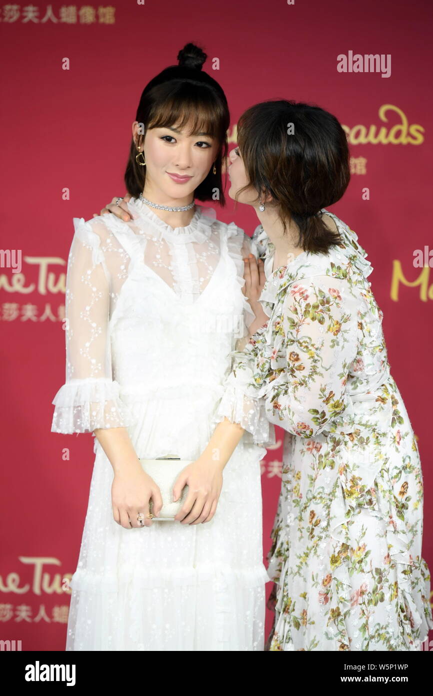 Chinese actress Andy Yang or Yang Zi looks at the wax figure of her ...