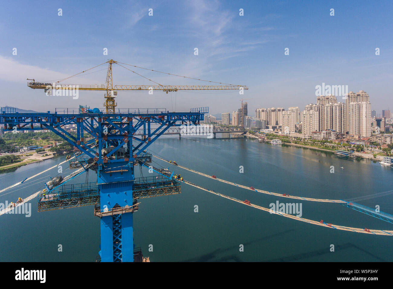 Chinese workers erect cables of Panggong suspension bridge across the ...
