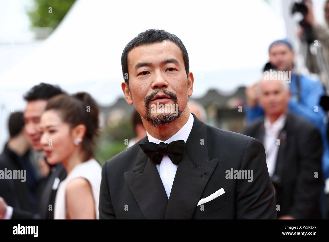 Chinese actor Liao Fan poses as he arrives on the red carpet for the ...