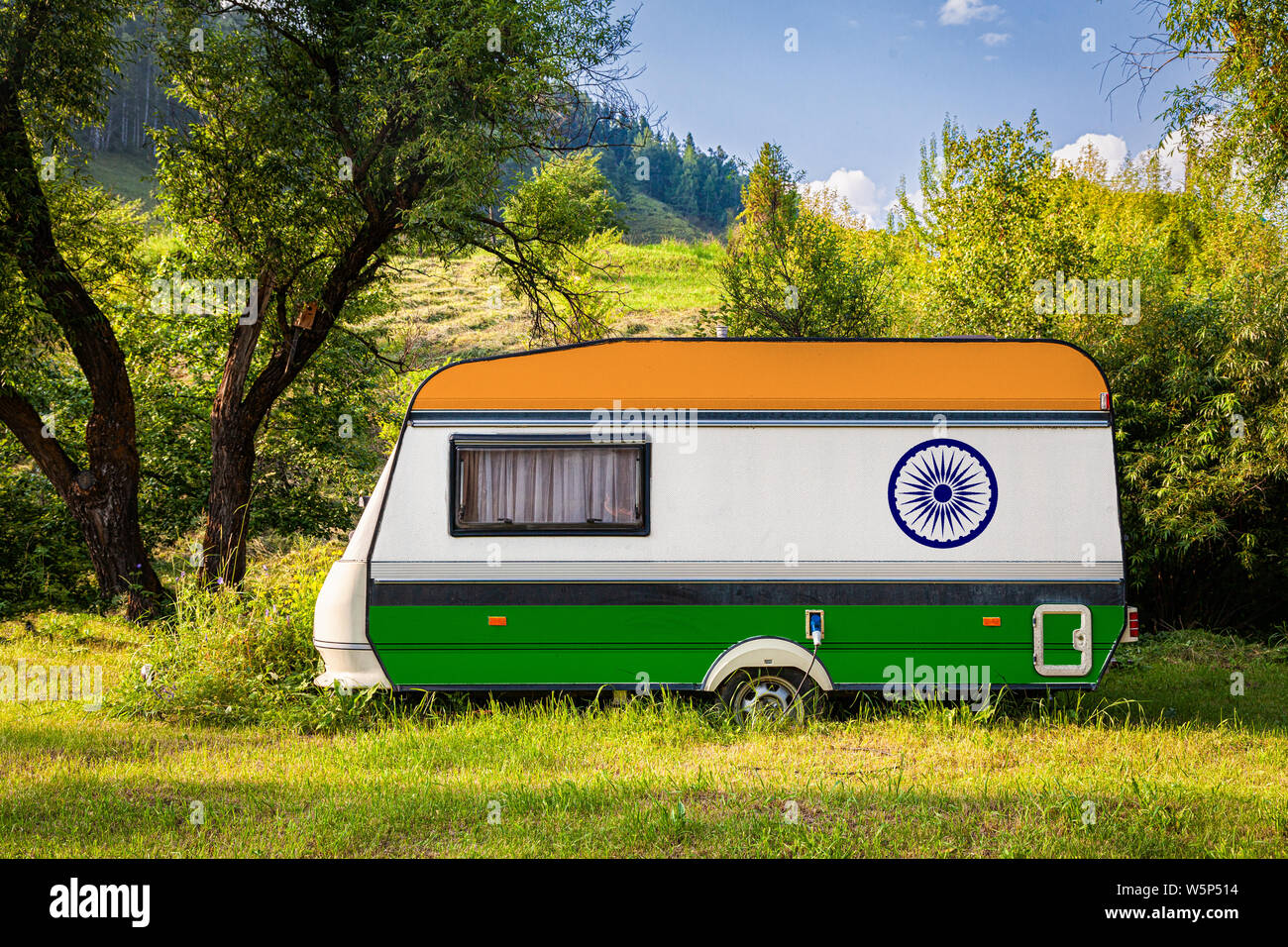 A car trailer, a motor home, painted in the national flag of India ...