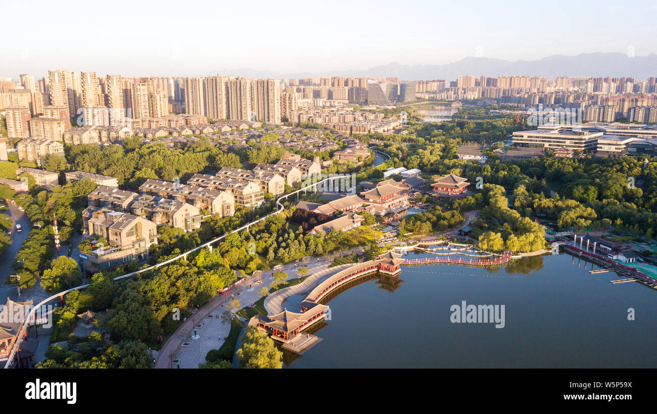 A cluster of villas with red and blue roofs along the Qujiang River in Qujiang New District, Xi ...