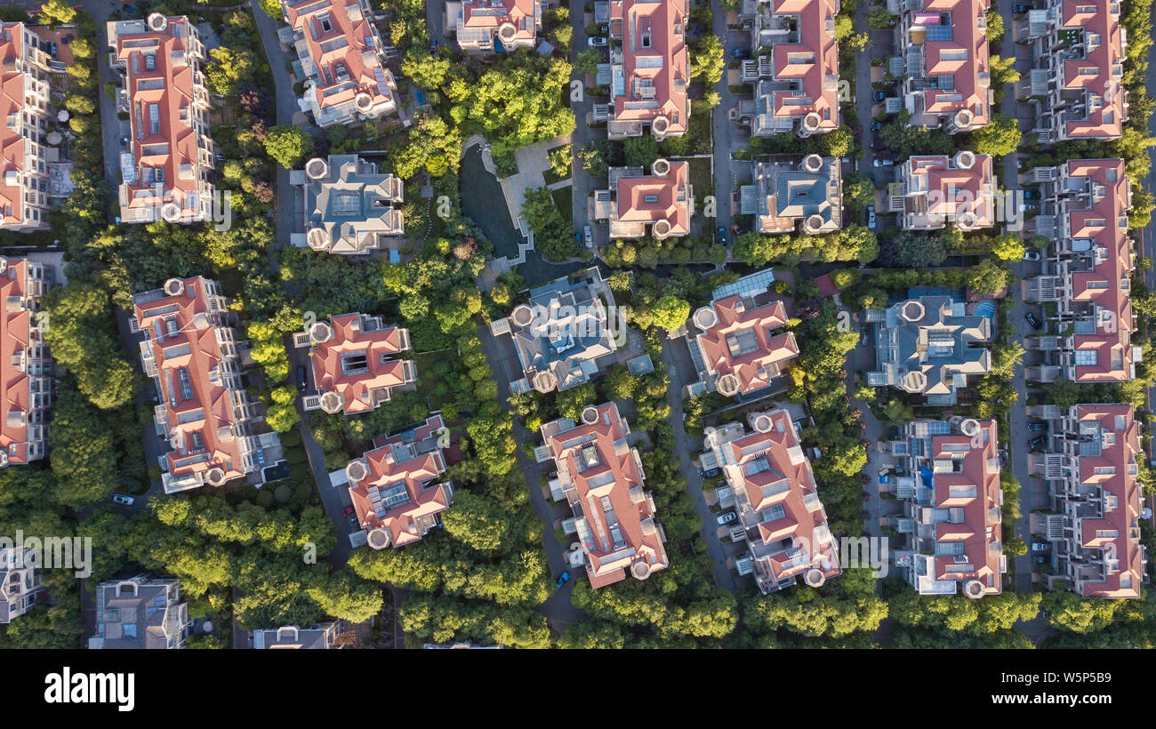A cluster of villas with red and blue roofs along the Qujiang River in ...