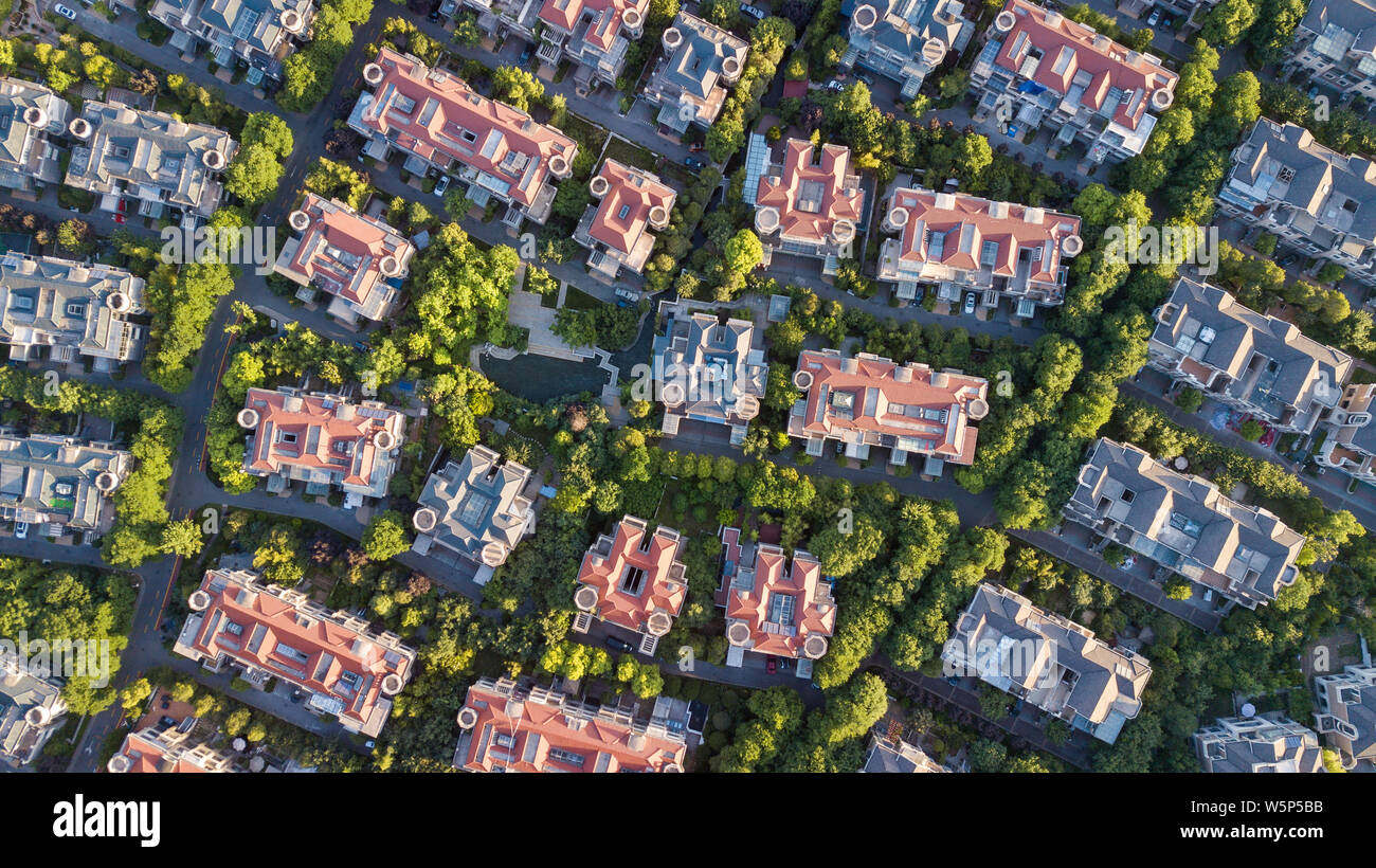 A cluster of villas with red and blue roofs along the Qujiang River in ...