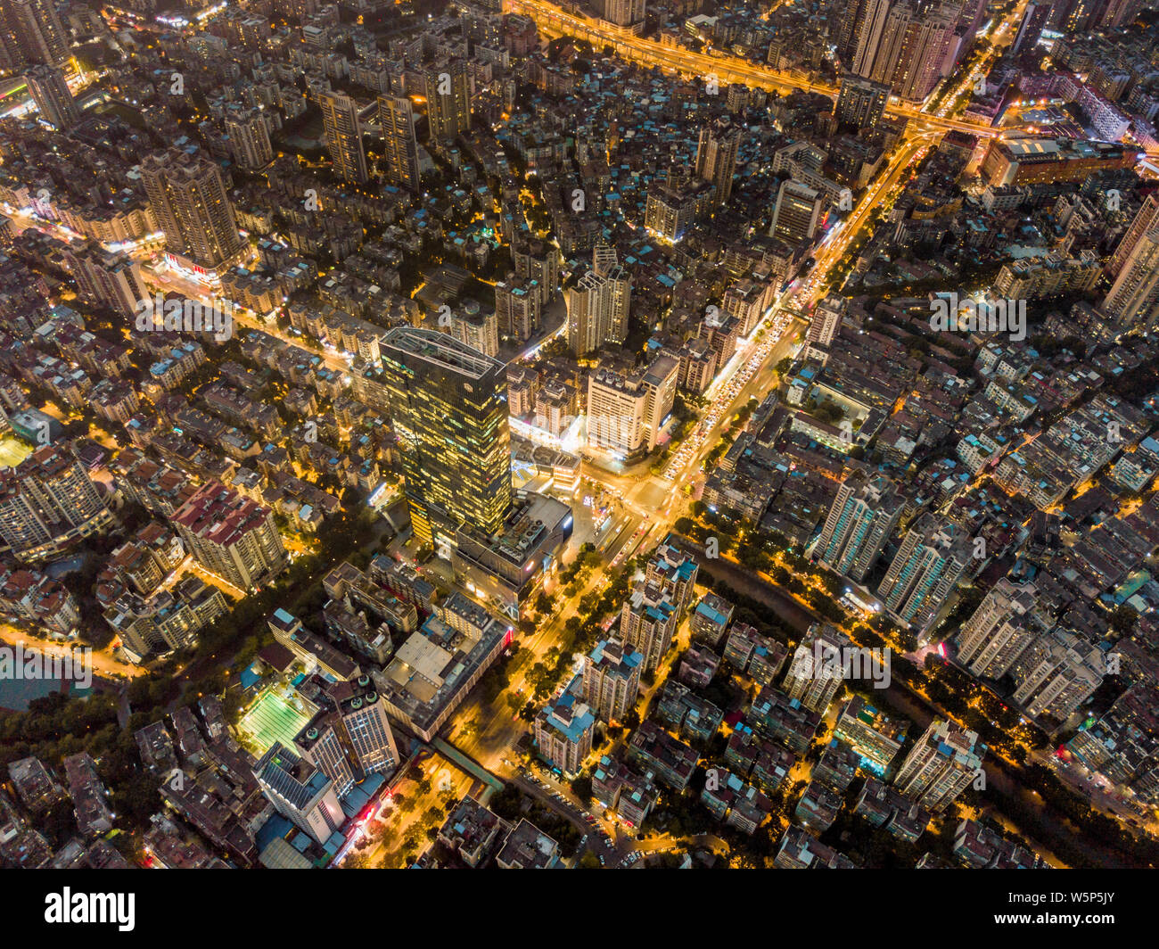 --FILE--An aerial night view of clusters of buildings and houses in ...