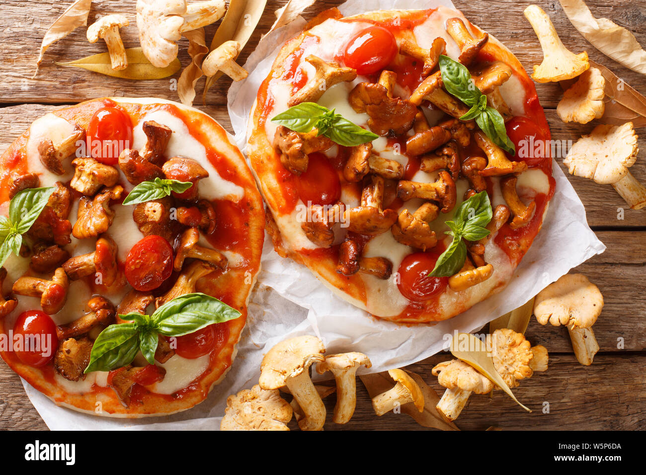 Delicious pizza with chanterelle mushrooms, mozzarella cheese, tomatoes ...