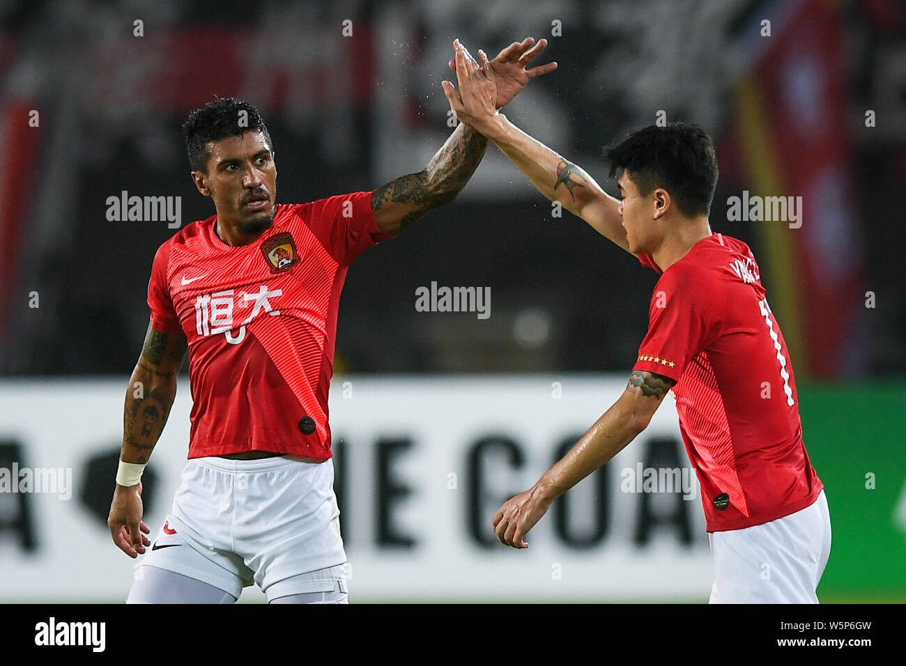 Brazilian football player Paulinho, left, of China's Guangzhou ...