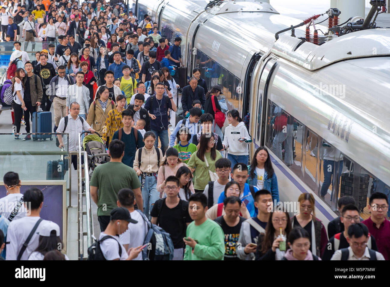 Chinese passengers who are back from the four-day Labor Day holiday ...