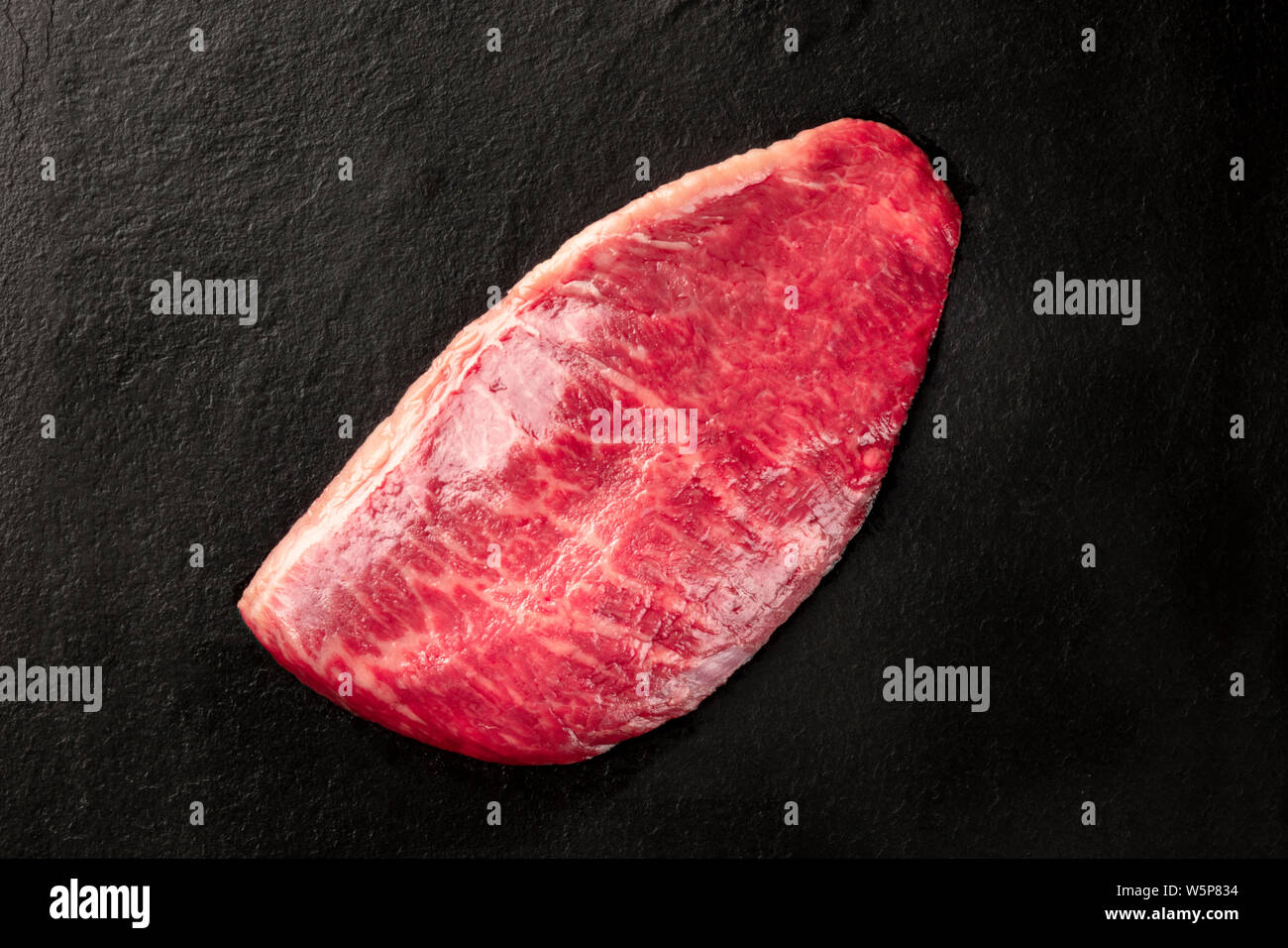 Kobe meat, wagyu beef steak, shot from the top on a black background ...