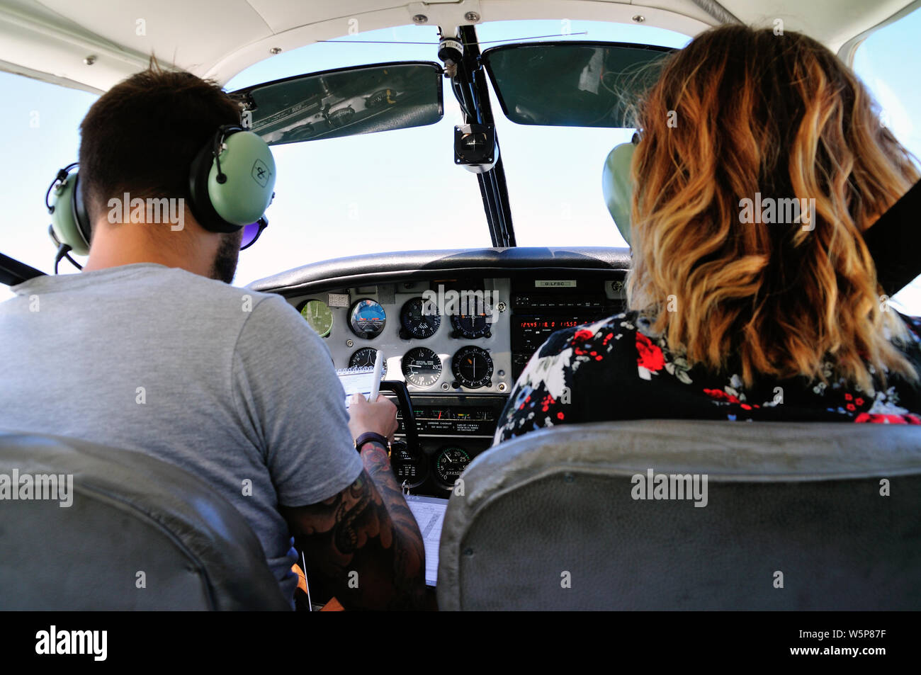 Pilot flying light aircraft Stock Photo - Alamy