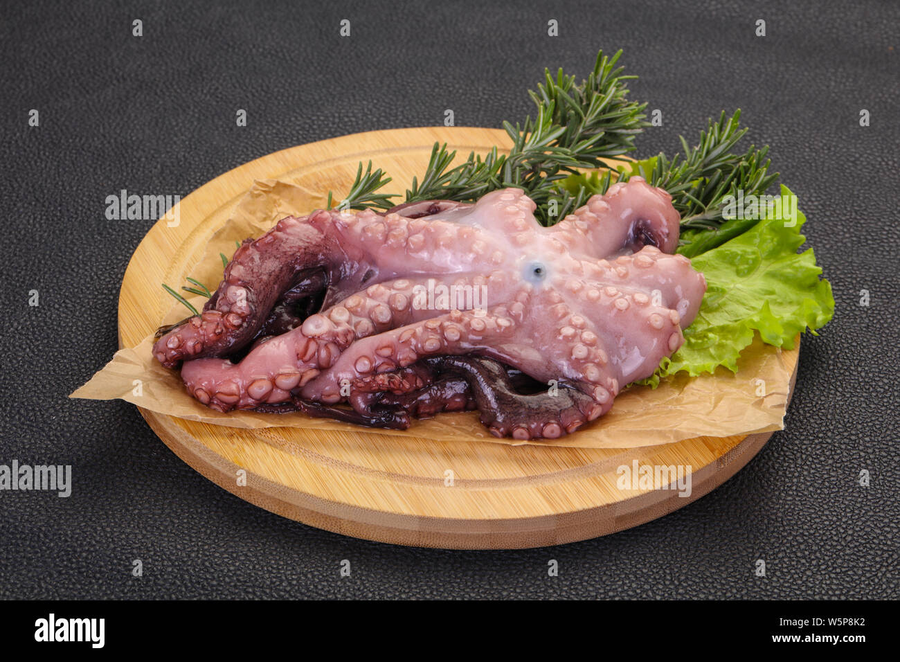Raw octopus ready for cooking with rosemary Stock Photo - Alamy
