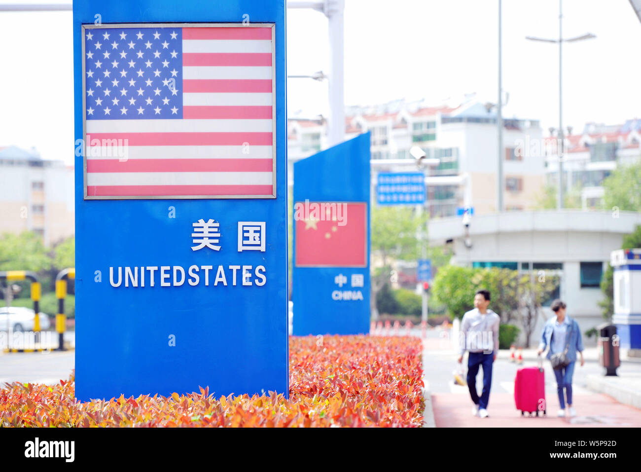 --FILE--Signboards showing the flag of the United States and Chinese ...