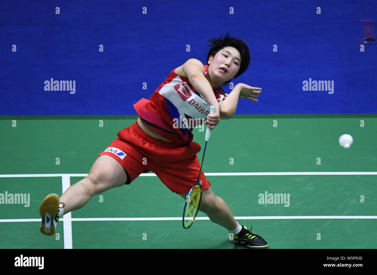 Akane Yamaguchi of Japan returns a shot to Chen Yufei of China in their final group 1 match of ...