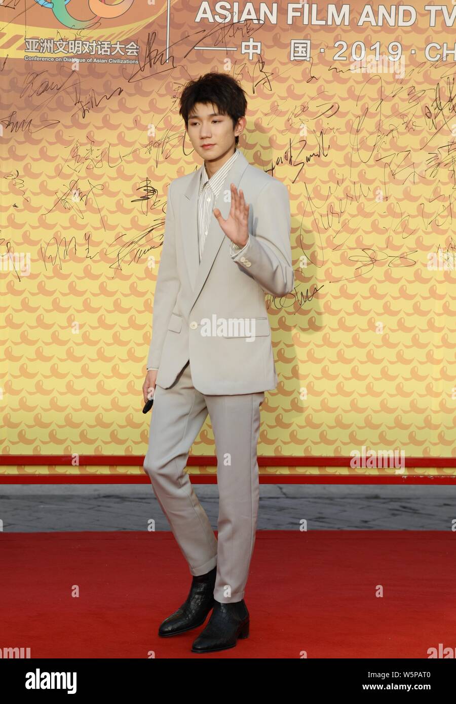 Roy Wang or Wang Yuan of Chinese boy group TFBoys poses as he arrives ...