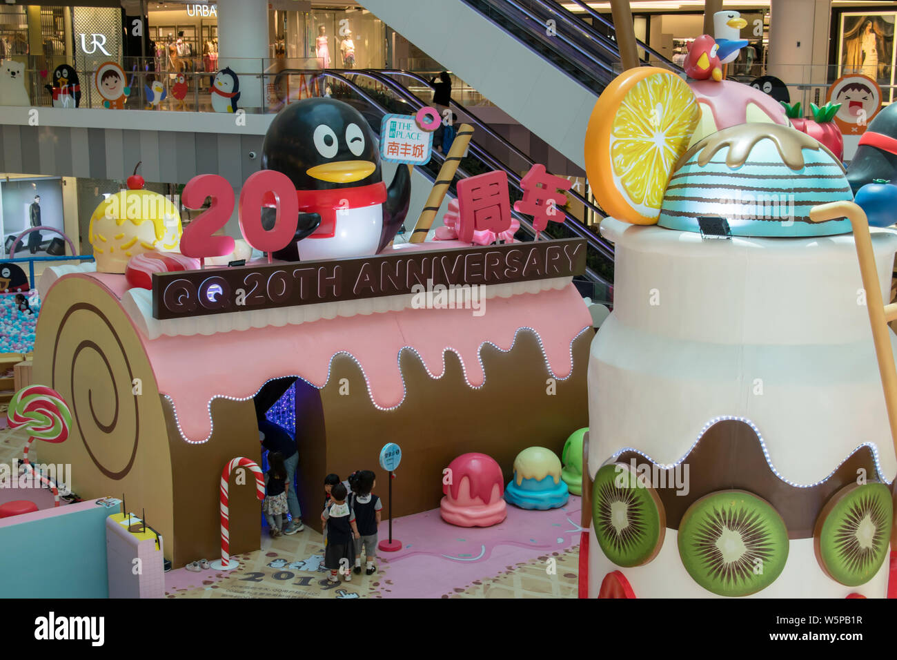 Customers enjoy themselves during an exhibition showcasing all the QQfamily members to celebrate ...