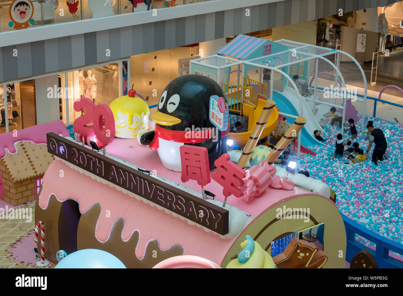 Customers enjoy themselves during an exhibition showcasing all the QQfamily members to celebrate ...