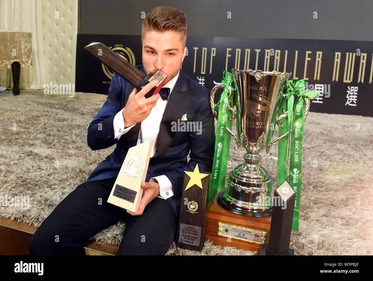 Brazilian football player Igor Sartori poses with his trophy after ...