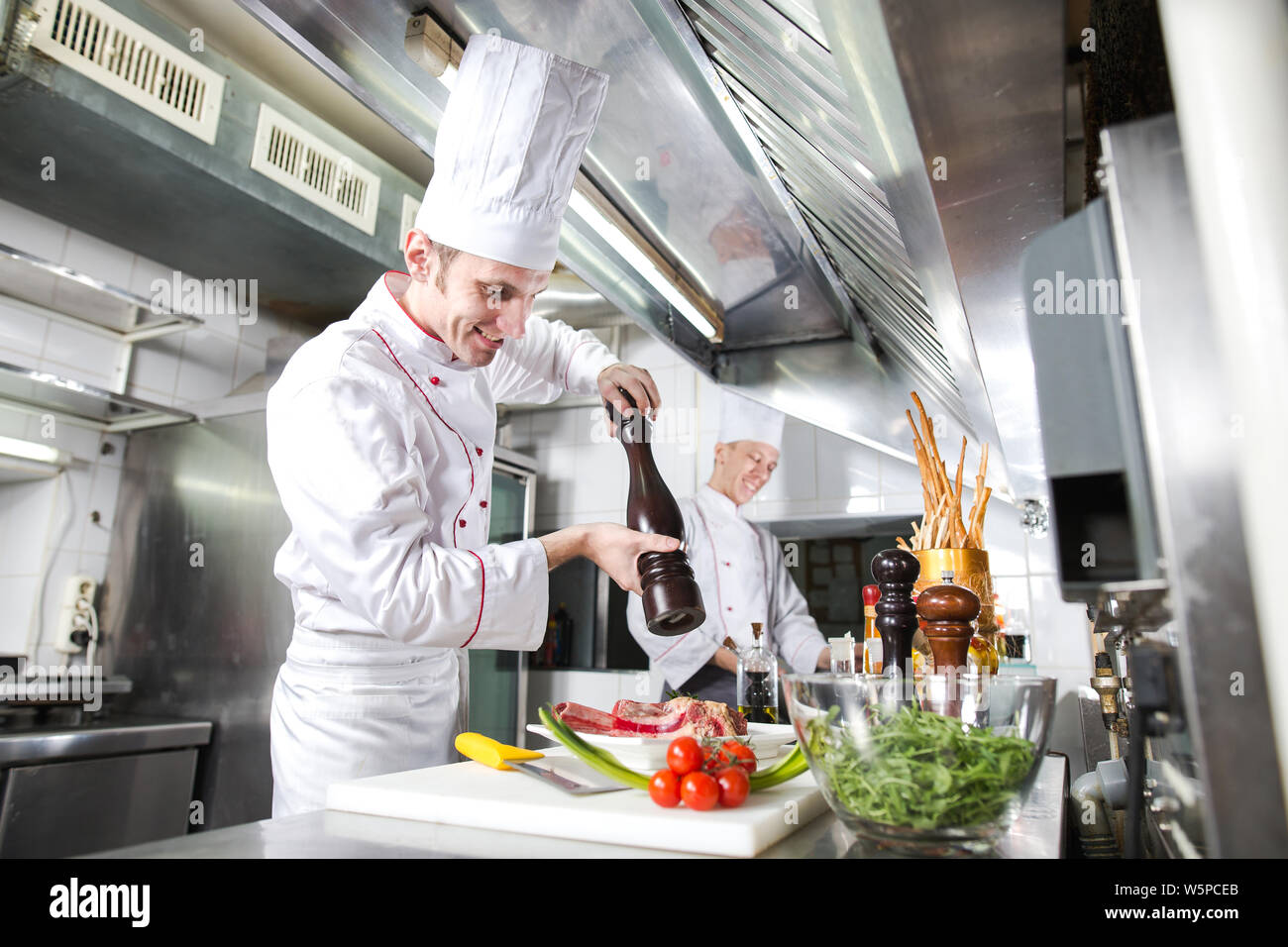 The chef prepares a dish in the kitchen of restoran Stock Photo - Alamy