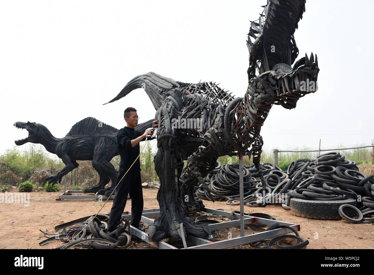 Chinese man Cao Shengge crafts an animal-shaped statue from used tires ...