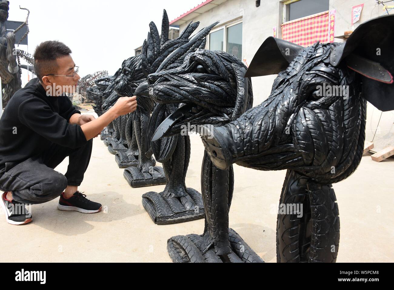 Chinese man Cao Shengge crafts an animal-shaped statue from used tires ...