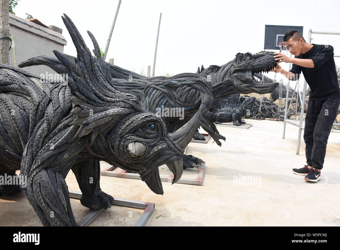 Chinese man Cao Shengge crafts an animal-shaped statue from used tires ...