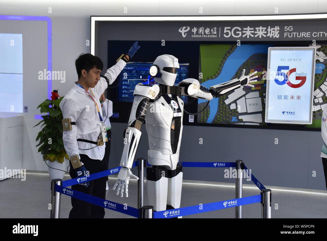 A smart robot is displayed at the stand of China Telecom featuring 5G ...